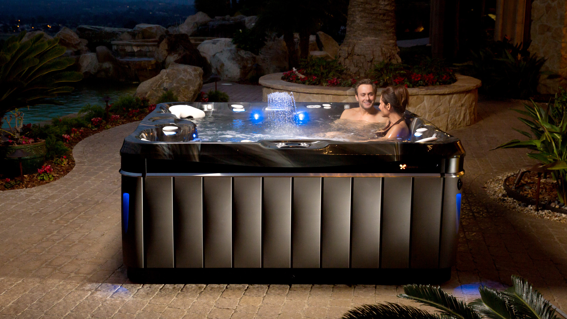 Couple in spa at night – Luxury Outdoor Living